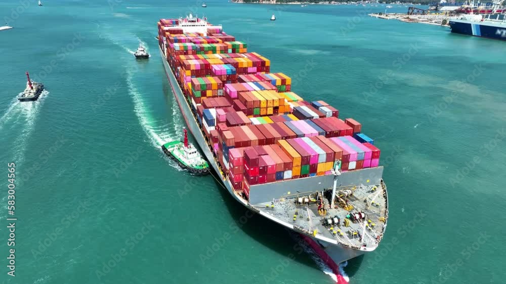 Aerial in front view of cargo ship carrying container and running for ...