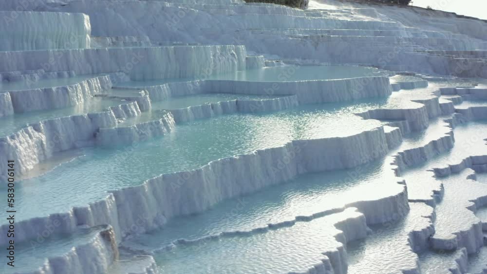 White travertine terraces or travertine pools that cascade down the ...