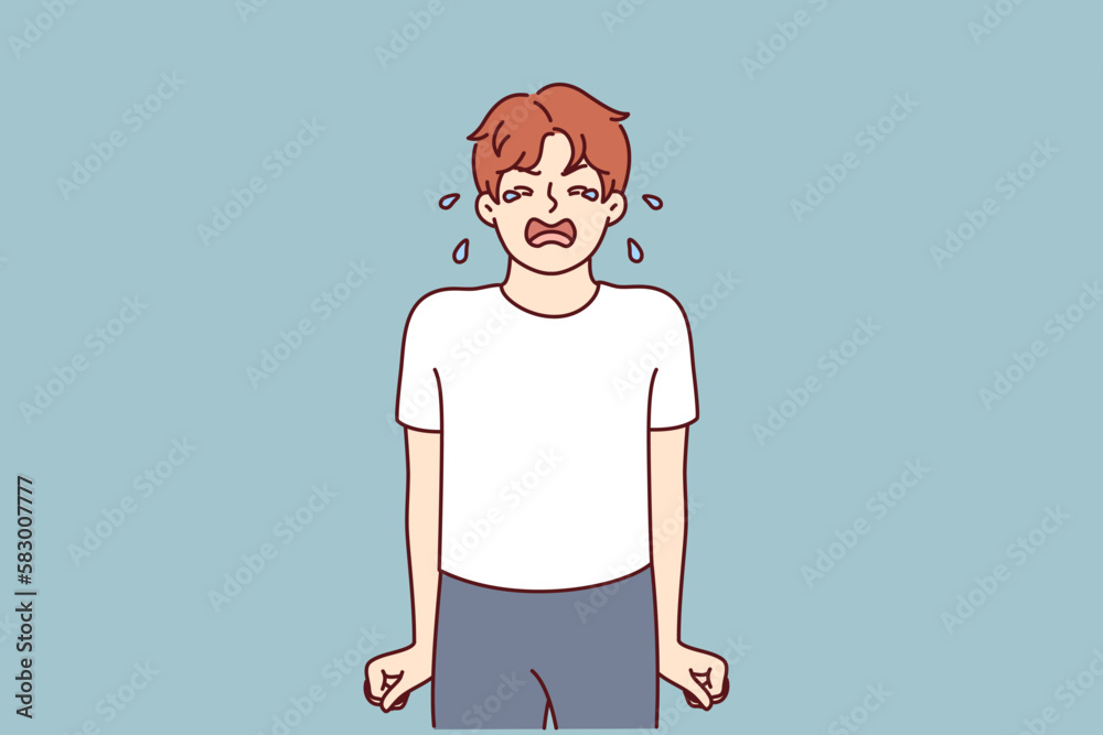 Crying teenage boy stands clenching fists nervous after receiving ...