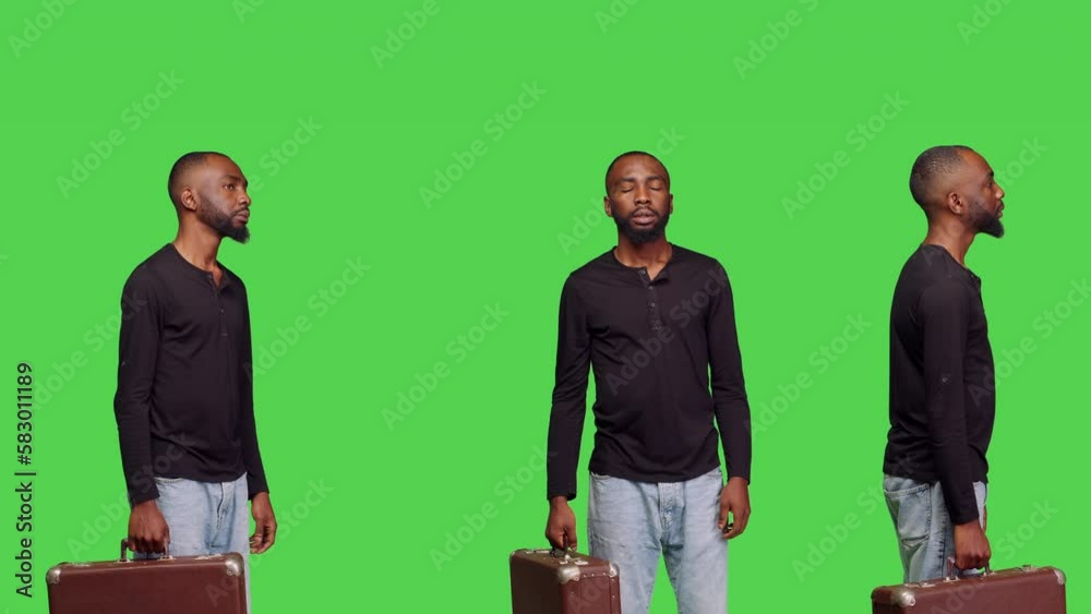 Male model carrying suitcase with luggage on camera, holding briefcase ...