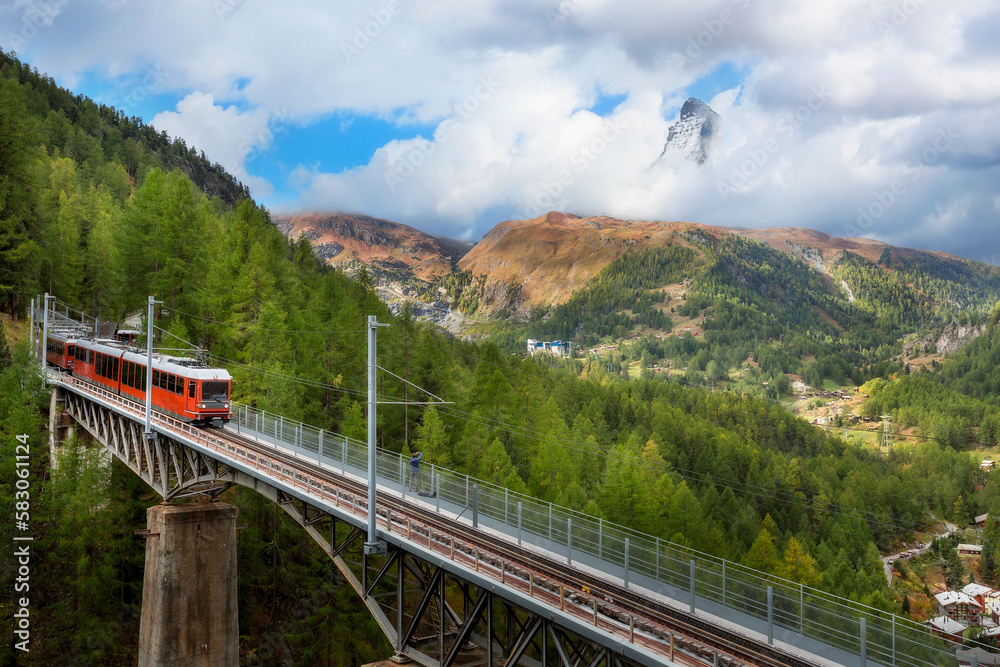 Zermatt, Switzerland. Gornergrat red tourist train on the bridge and ...