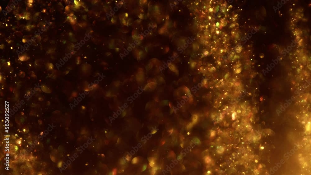 Golden glitter background in slow motion. Beautiful transition with real gold particles flying ...