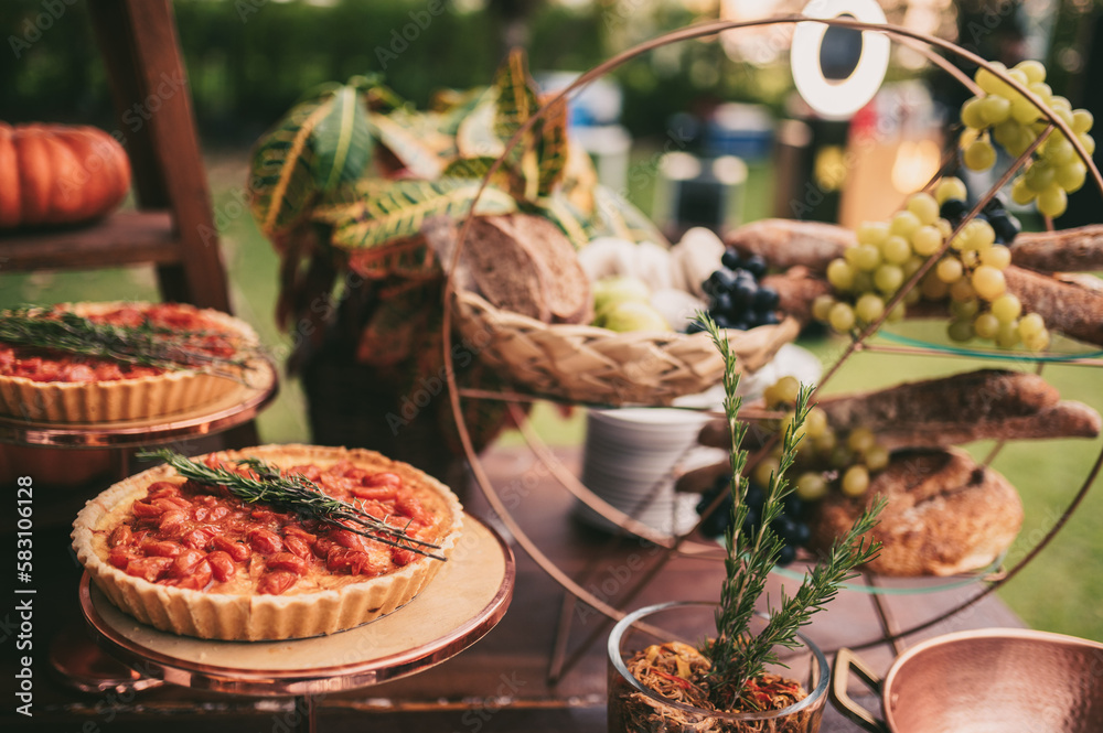 Foto de The board is set up on a long buffet table. The cheeses are ...