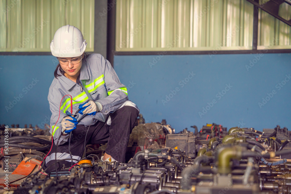 Female engineer wearing uniform Form and safety helmet inspecting ...