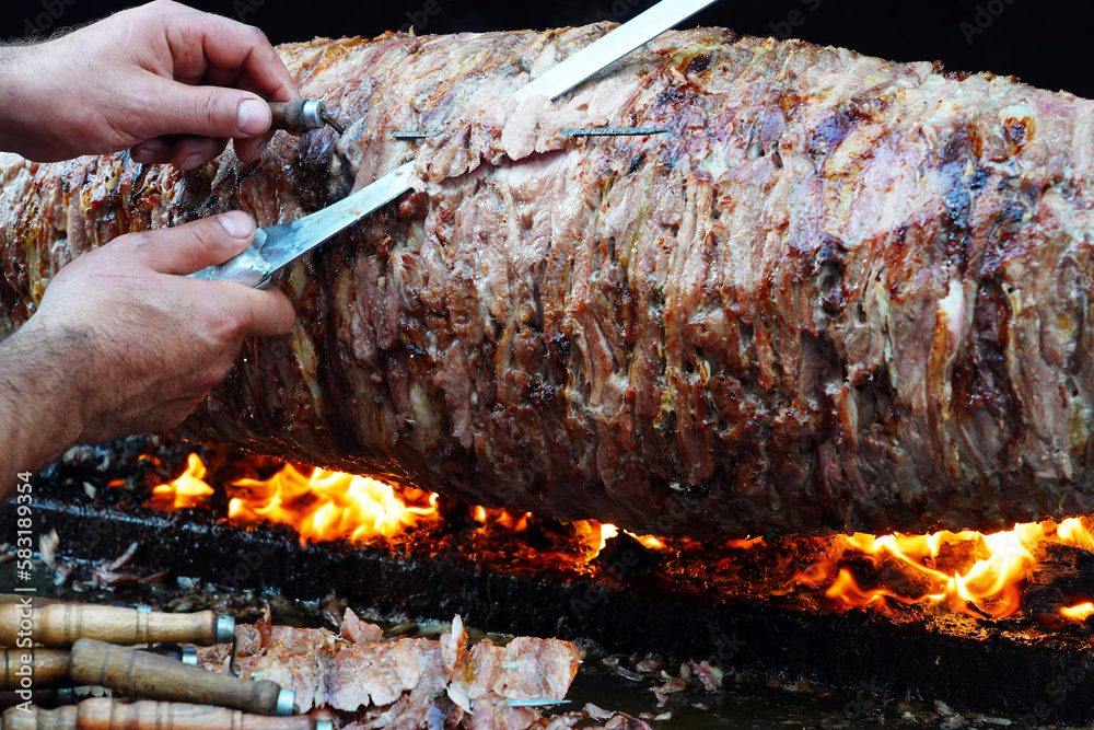 flat doner kebab meat being cut before making a sandwich erzurum oltu ...