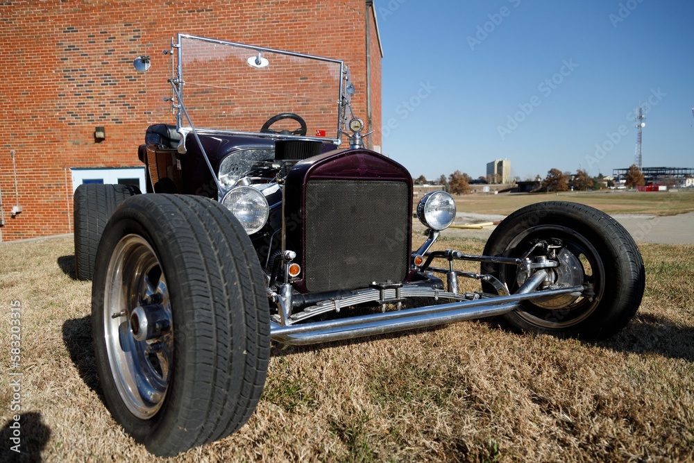 Selective closeup focus of a vintage Ford Model T in front of a red ...