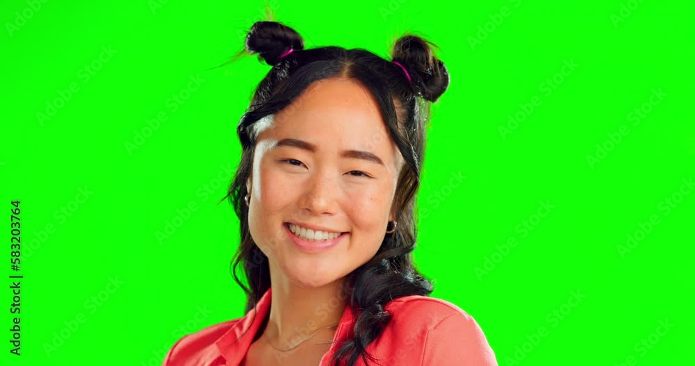 Asian woman, wink and face with green screen in a studio feeling ...