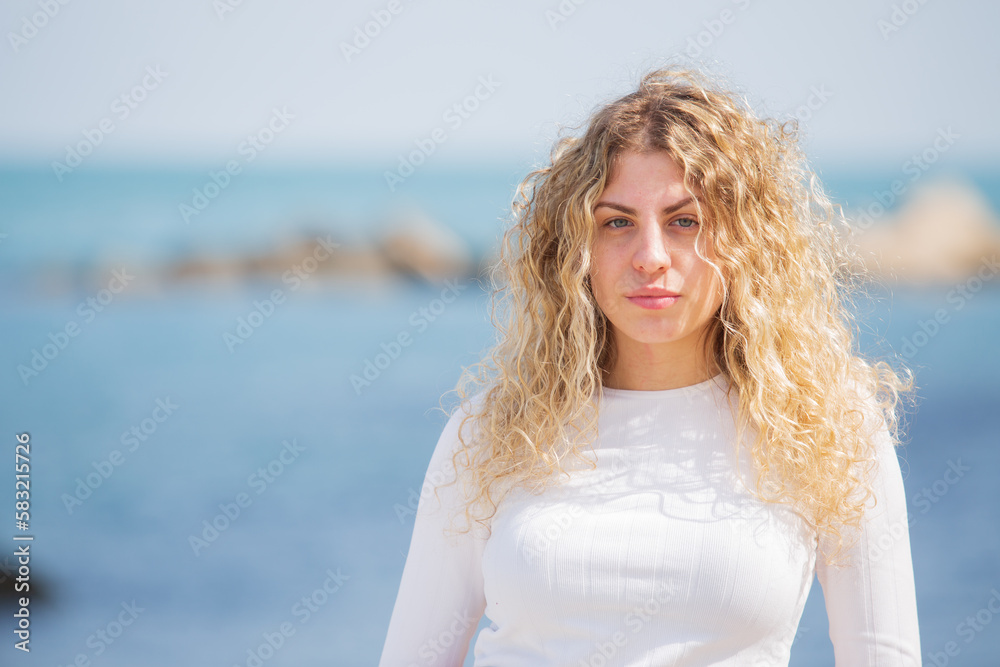 Beautiful Italian girl with long curly hair and white t-shirt at the ...