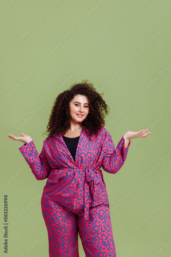 A young woman with a large figure in a bright suit depicts scales with ...