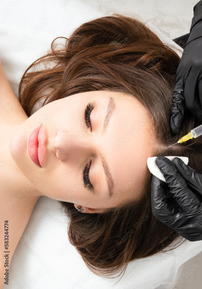 Mesotherapy, vitamin injections in head skin of hair area. Professional ...