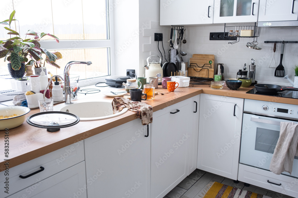 A mess in the kitchen, dirty dishes on the table, scattered things ...