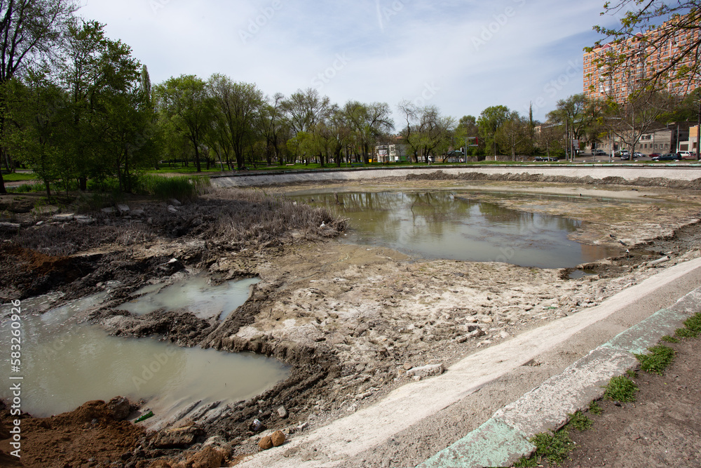 Ecological catastrophy. Drying lake in city park. Dry swamp lake ...