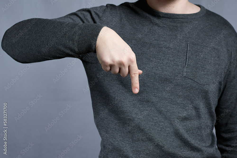 Hand with index finger pointing downward. A directional sign or ...