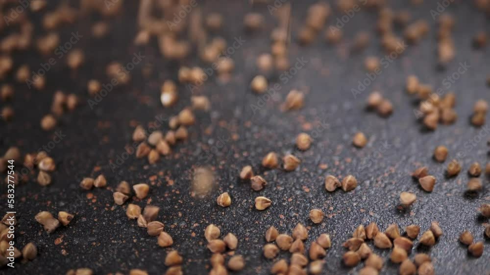 Grains of Buckwheat Fall on a Black Background in Slow Motion. Close up ...