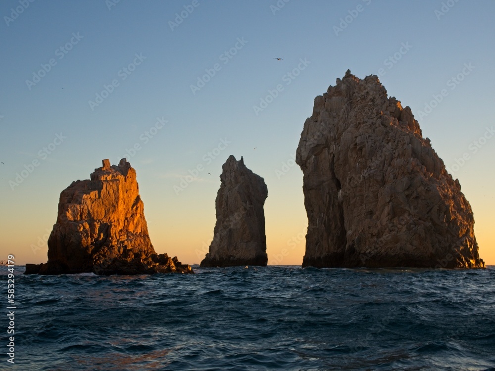 Rock formations jut out of the turbulent Pacific waves off the end of ...