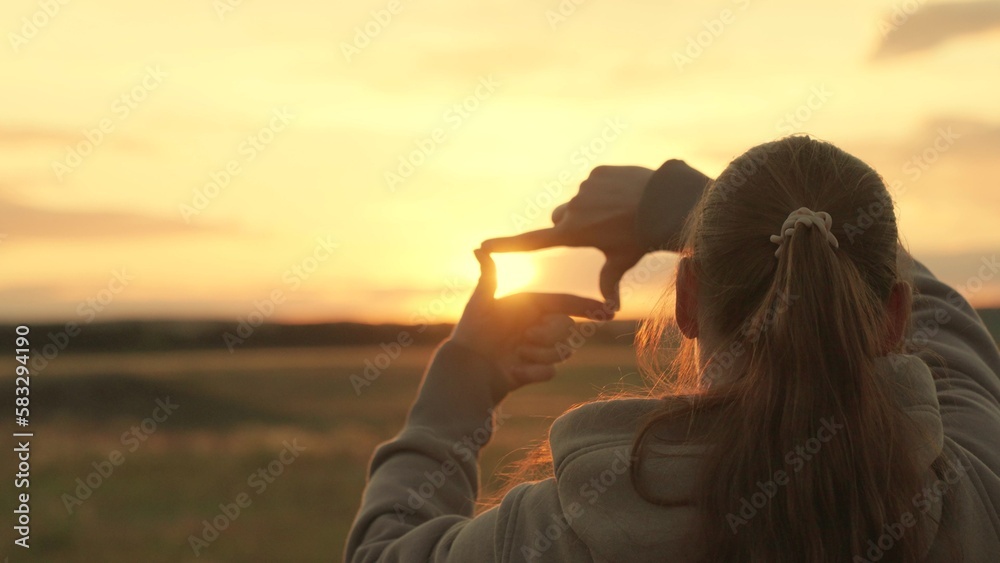 Girl shows her fingers frame symbol, sun. Hands of young female ...