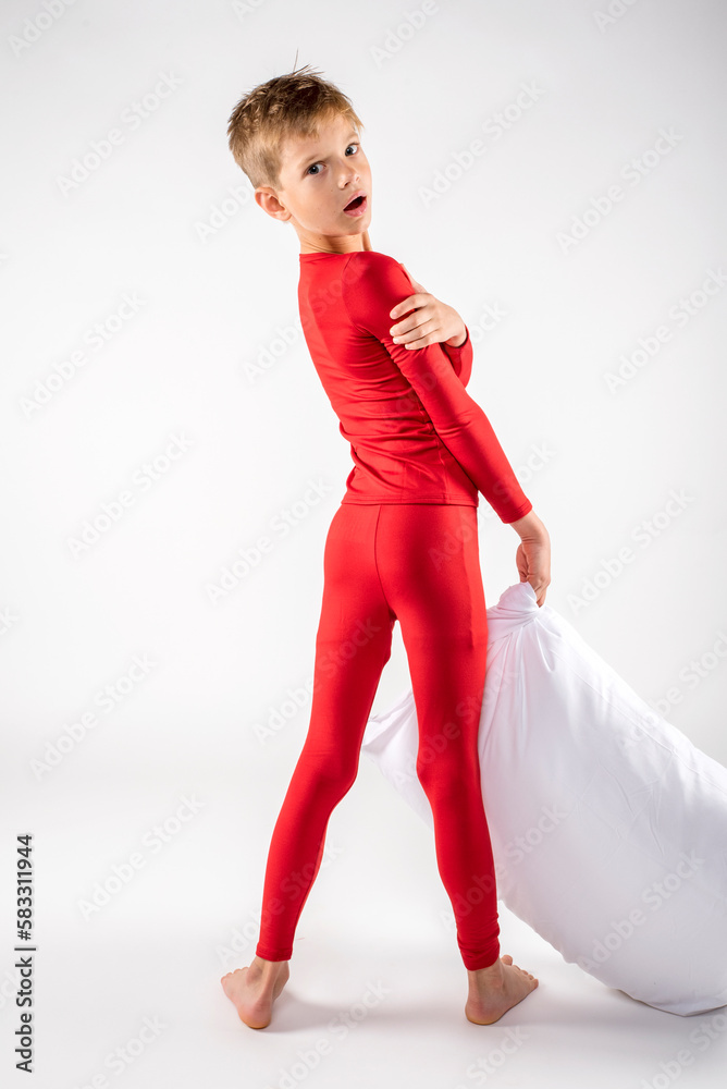 Young preteen boy in pajamas with pillow in studio Stock Photo | Adobe ...