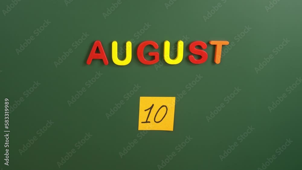 Hand sticking a sticker 10 August calendar day on school board. 10 date ...