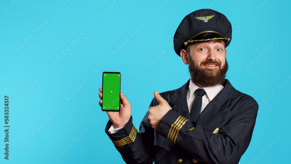 Smiling male aviator using telephone with greenscreen, holding ...