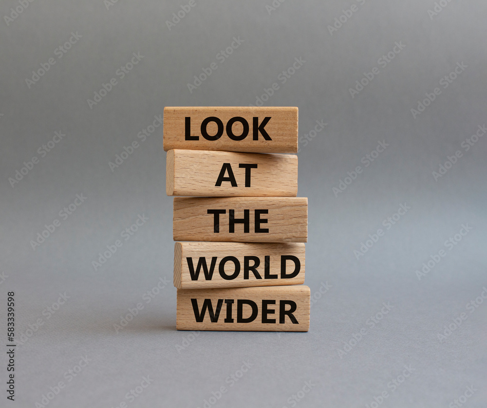 Look at the world wider symbol. Wooden blocks with words Look at the ...