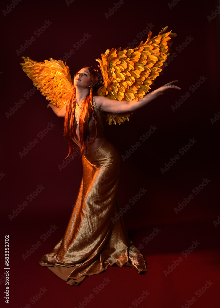 Full length portrait of beautiful woman model with long red hair, gold ...