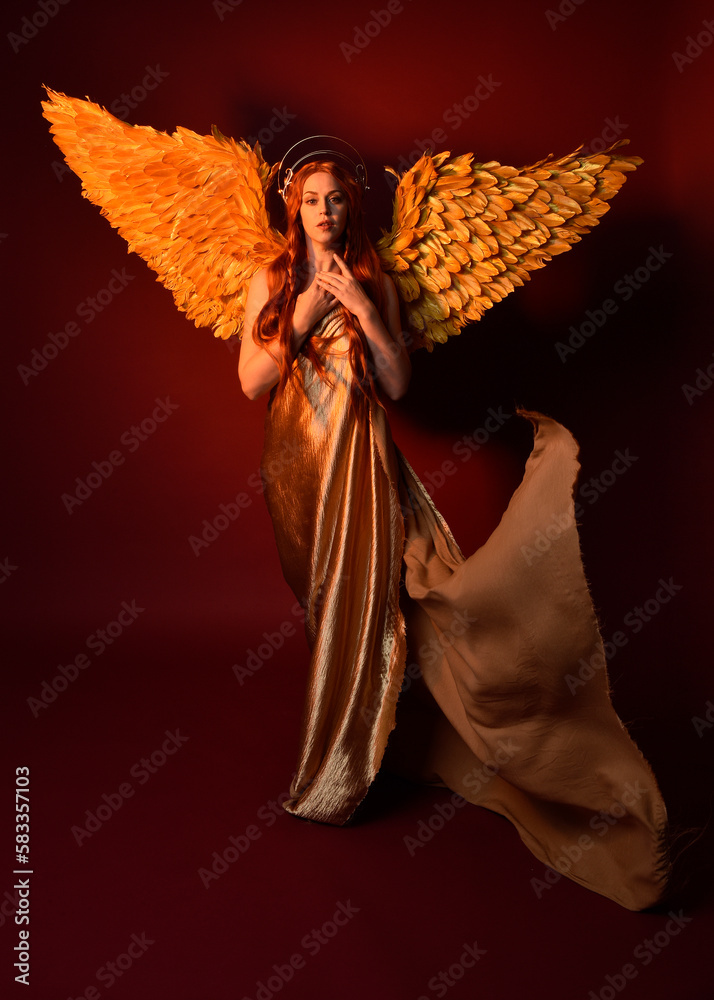 Full length portrait of beautiful woman model with long red hair, gold ...