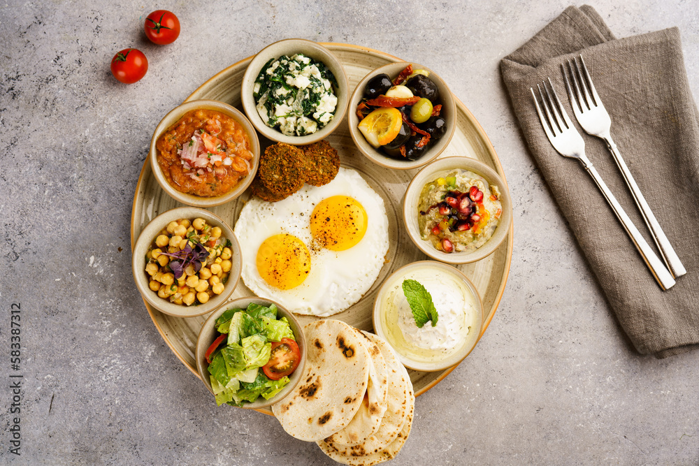 Lebanese Breakfast with hummus, salad, sunny egg, chickpeas, bread ...