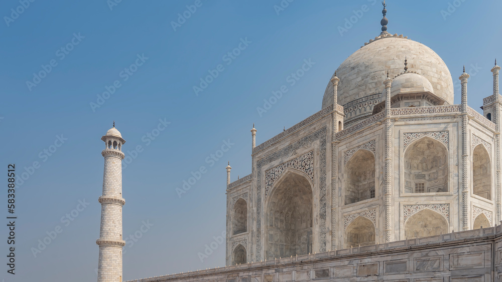 Beautiful white marble Taj Mahal against the blue sky. Symmetric ...