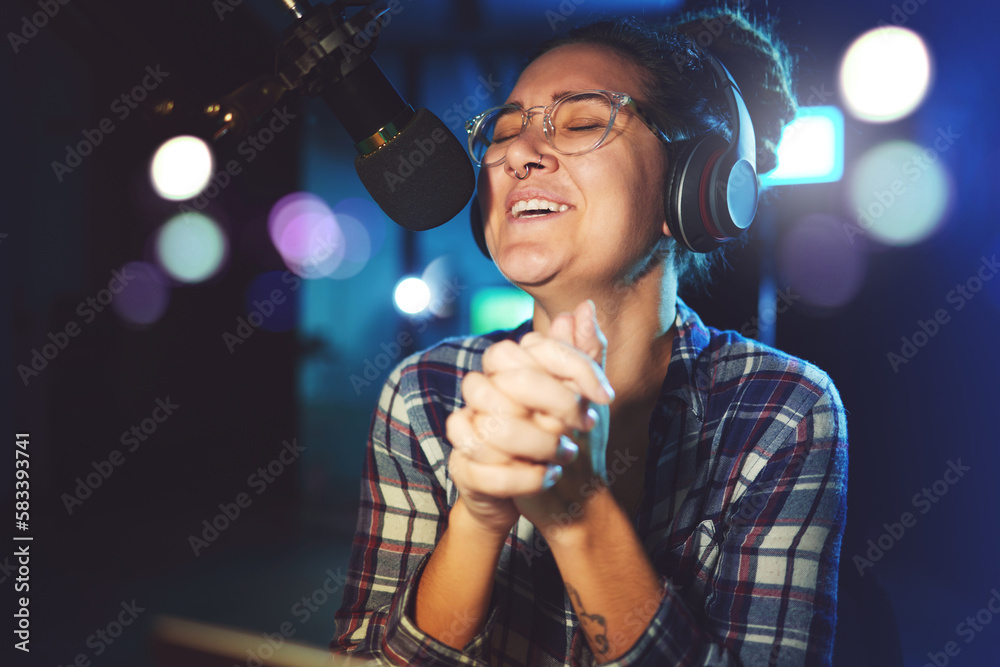 Radio DJ, headphones and microphone, woman is excited with singing or ...