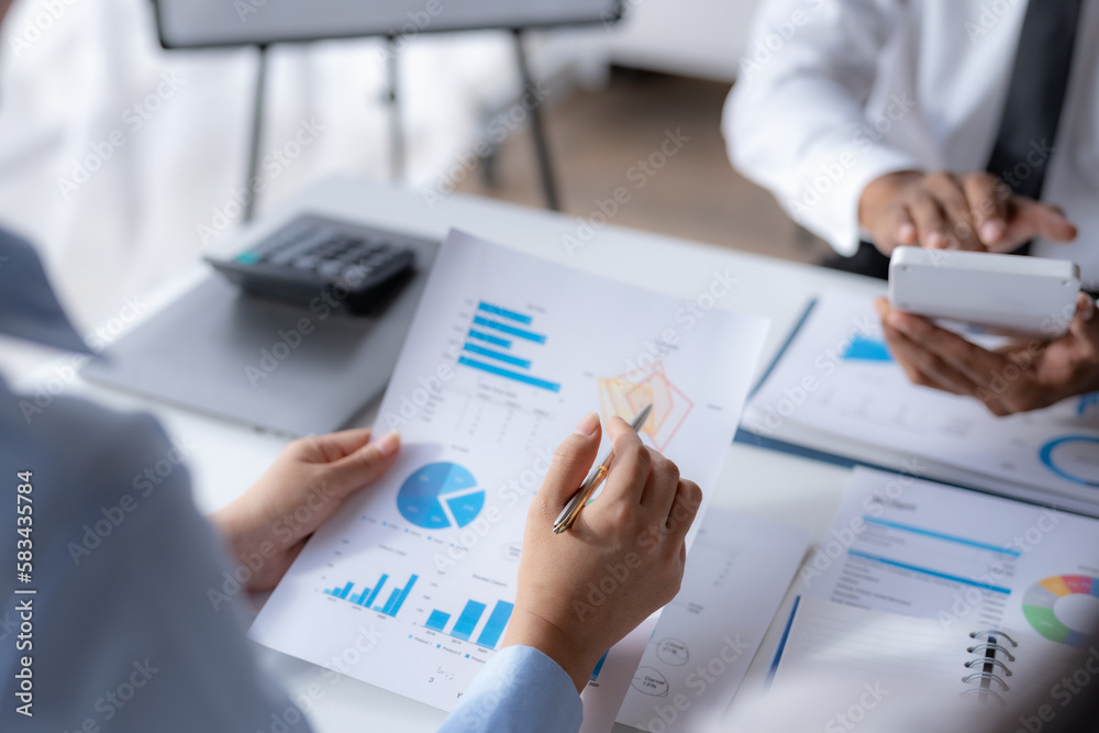 Business team together making investment plan at meeting pointing at ...