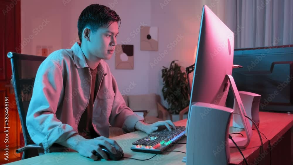 Waist up of Asian gen z gamer playing exciting online computer game in ...