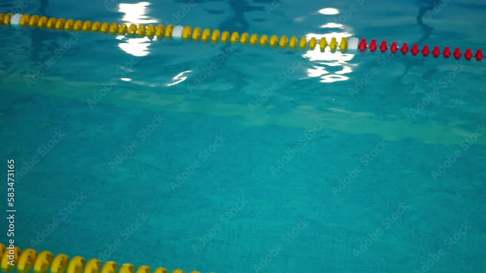 Live camera panning right to left along swimming pool track with young ...