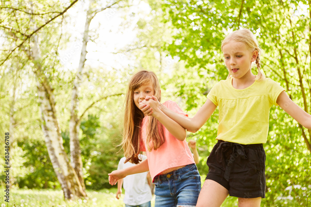Girls in three legged race competition at garden Stock Photo | Adobe Stock