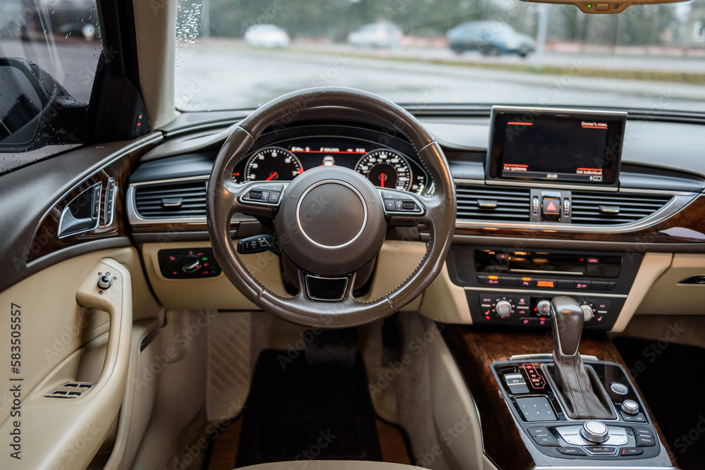 Luxury modern car interior business class. Steering wheel, shift lever ...