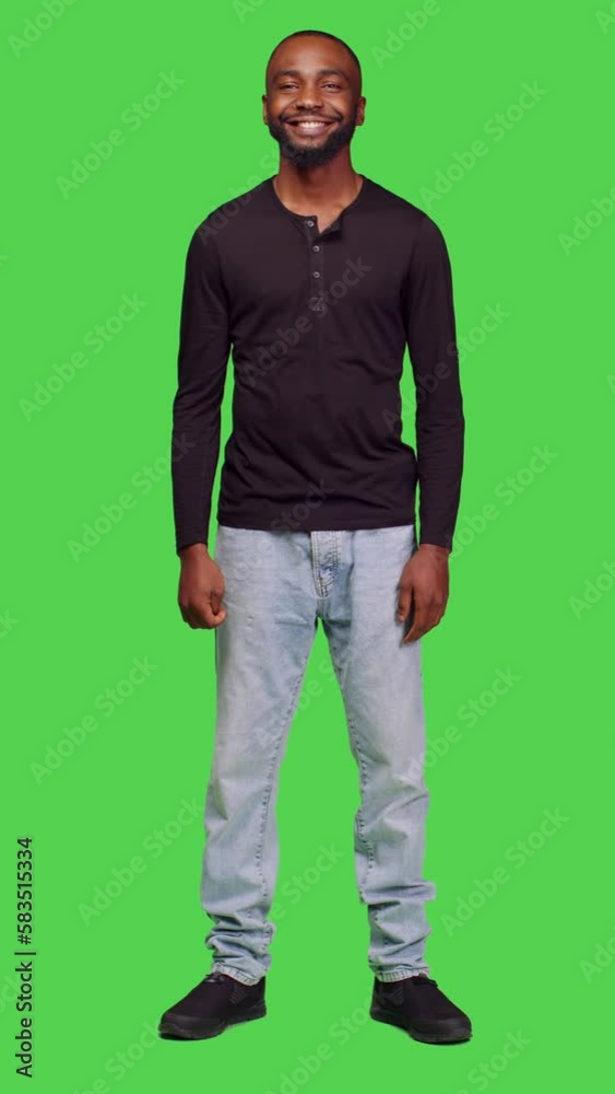Vertical video: Front view of african american person smiling in studio ...