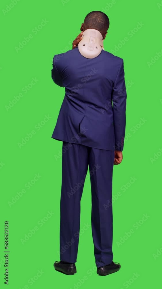 Vertical video: Back view of injured businessman wearing suit and ...