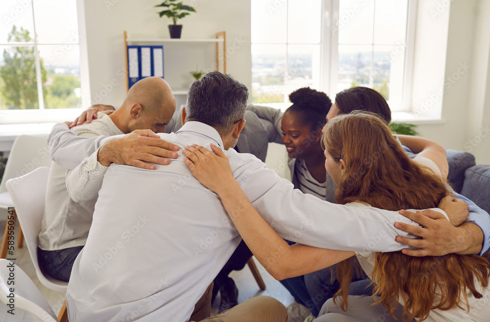 Team of multiracial workers huddling in the office. Group of happy ...
