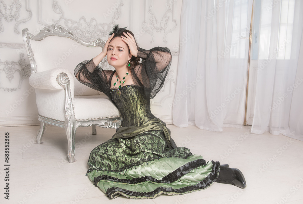 Sad crying woman wearing green medieval vintage Victorian Style dress ...