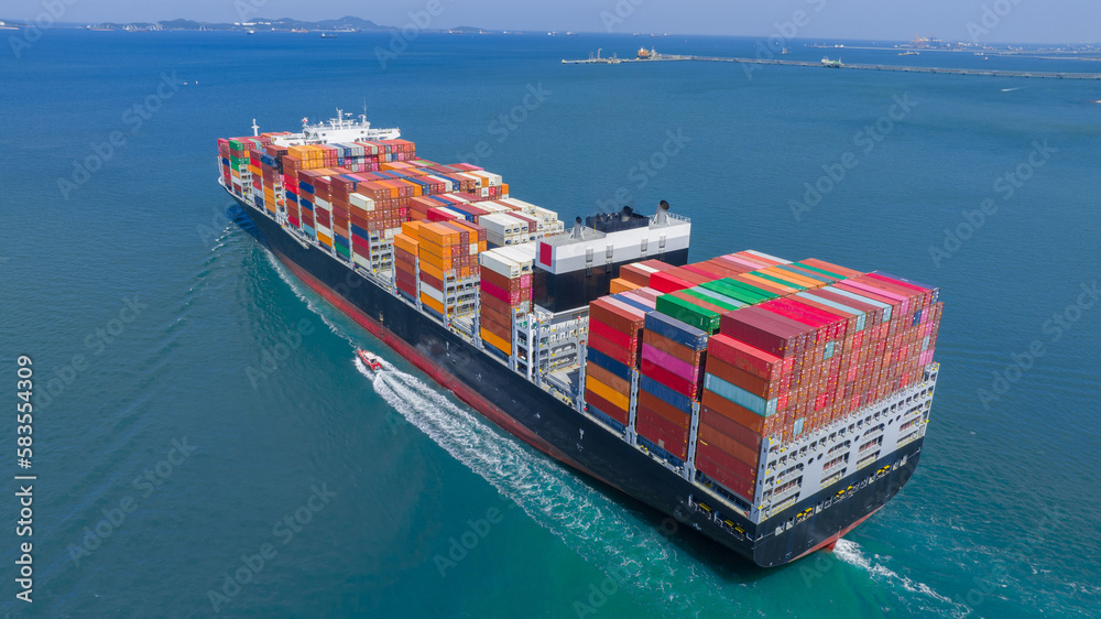 Stern of cargo ship carrying container and running for import goods ...