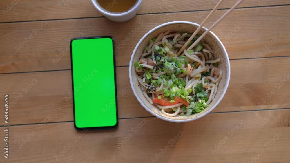Top view of plate with wok noodles next to green screen chroma key ...