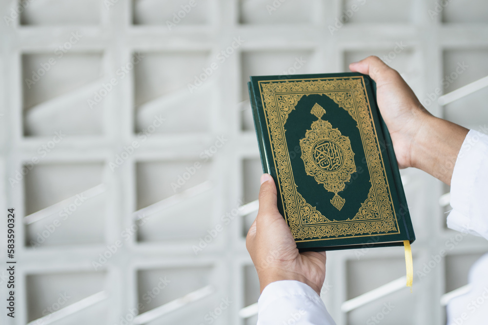 Foto de Holy Quran in Hand with arabic calligraphy meaning of Al Quran ...