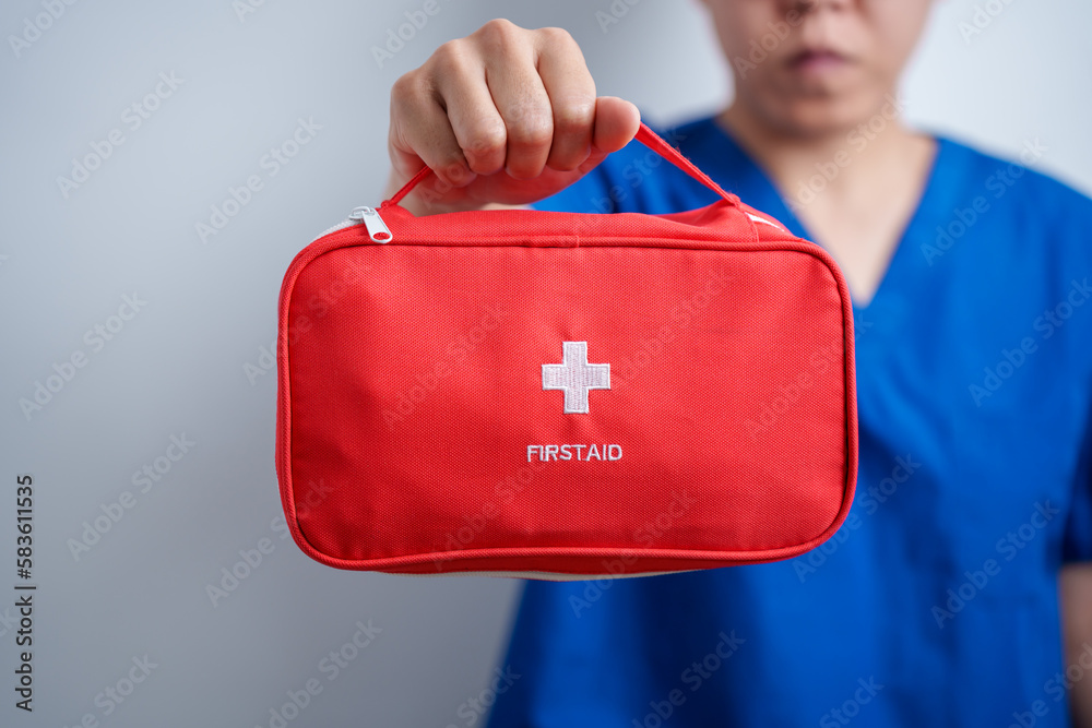 Nurse in medical scrub suit holding first aids kit bag for emergency at ...