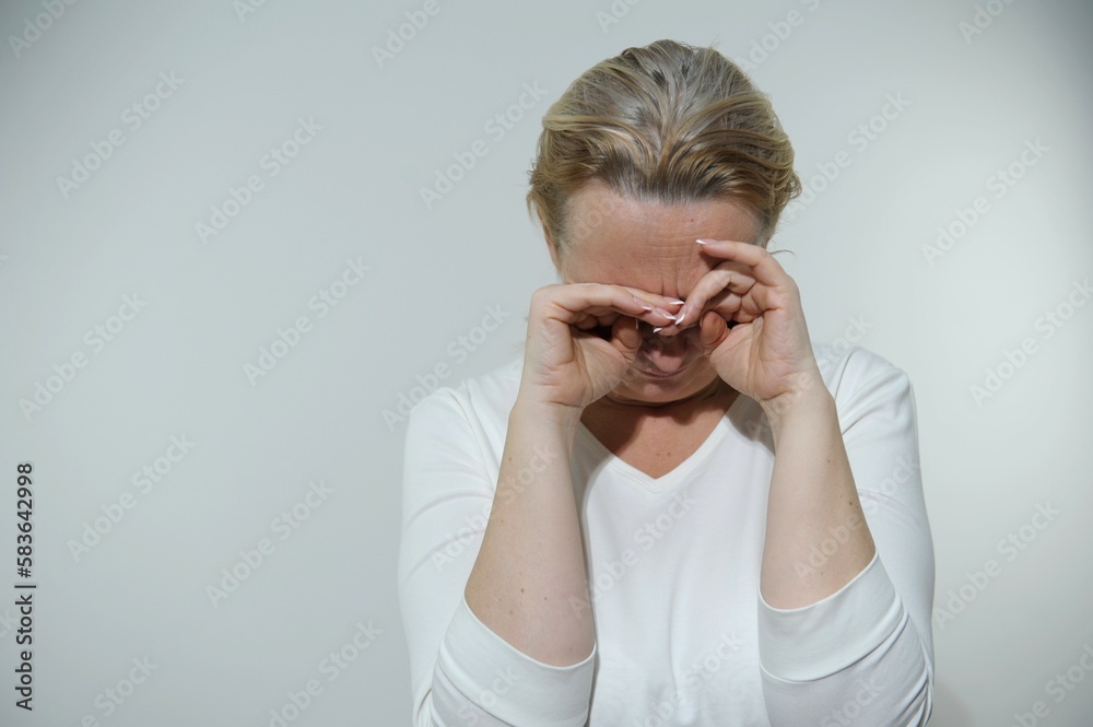 Sad tired woman touching forehead having headache migraine or ...