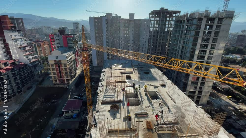 Construction of a multi-storey building, working high crane in high ...
