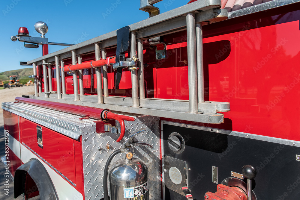 Beaching fire pick ax and sturdy extension ladder is firmly secured to ...