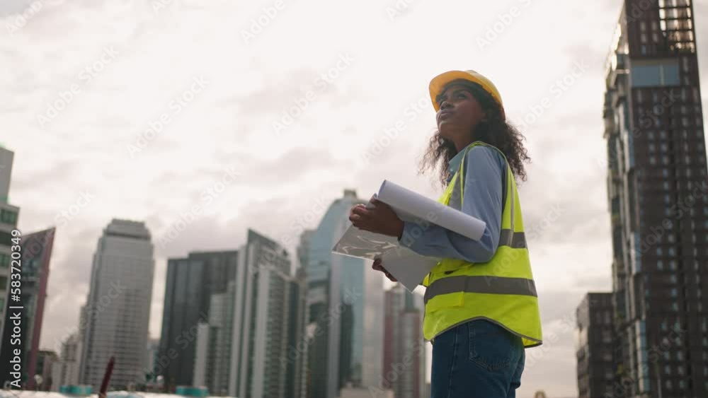 Civil engineer woman dark skin wearing uniform and safety helmet under ...