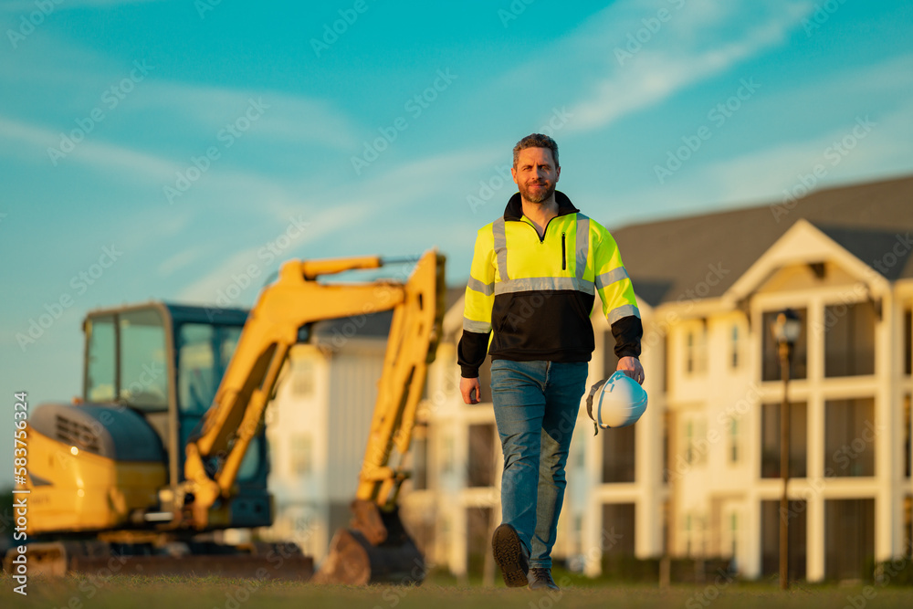 Builder with excavator for construction at the construction site ...