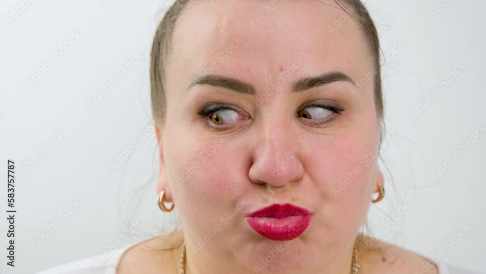 fat cheerful cute adult woman grimacing at the camera showing tongue ...