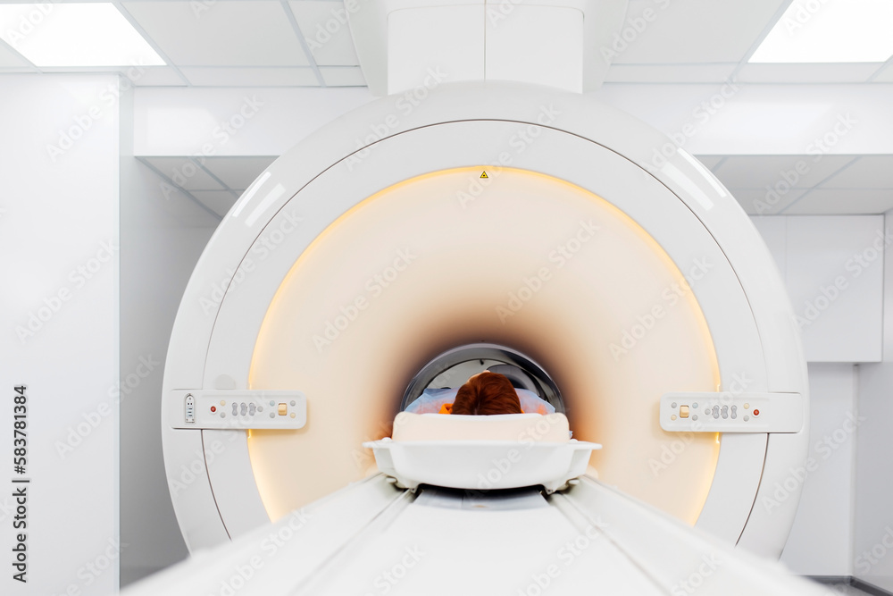 Young patient on automatic table moving outside of closed-type mri ...
