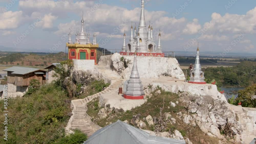 Taw Kyet Mountain Pagoda in front of shallow lake, near Loikaw Myanmar ...